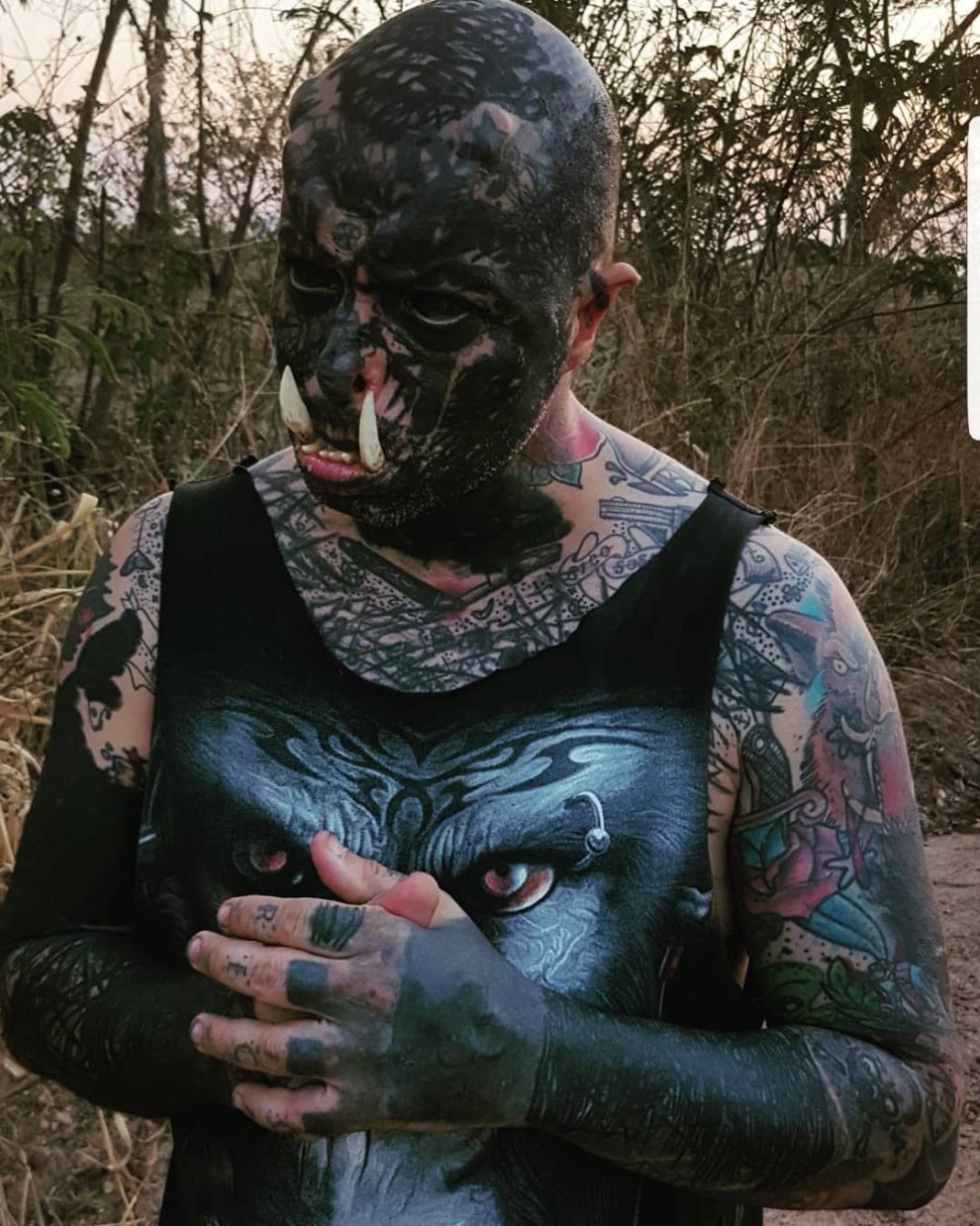 Real-Life Orc: Brazilian Tattoo Artist Has Giant Tusks Implanted to ...